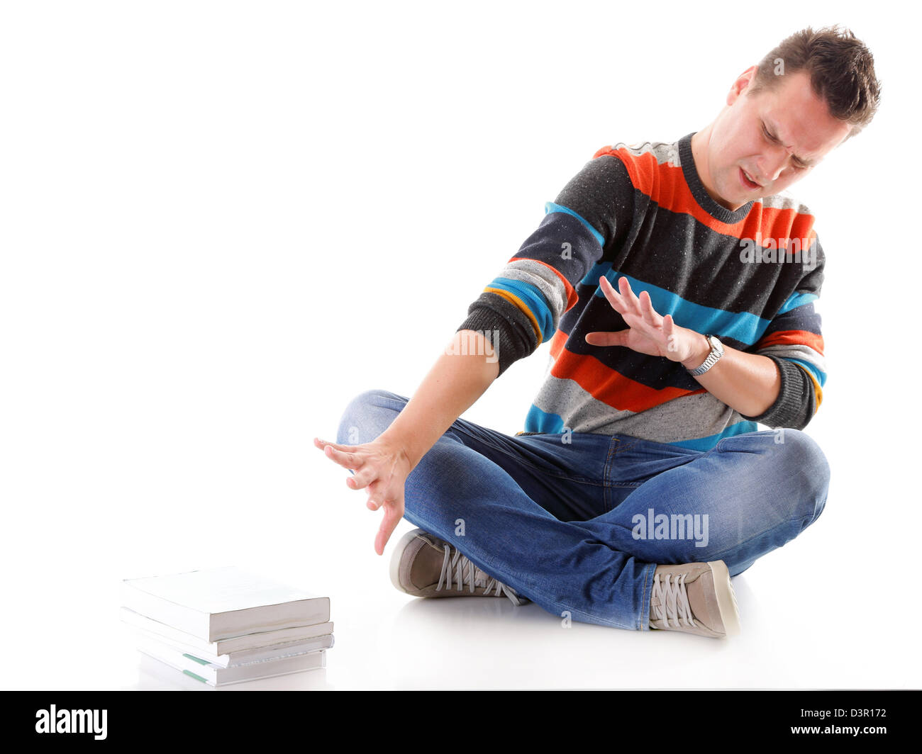 Exhausted and tired student with pile of books on white background ...