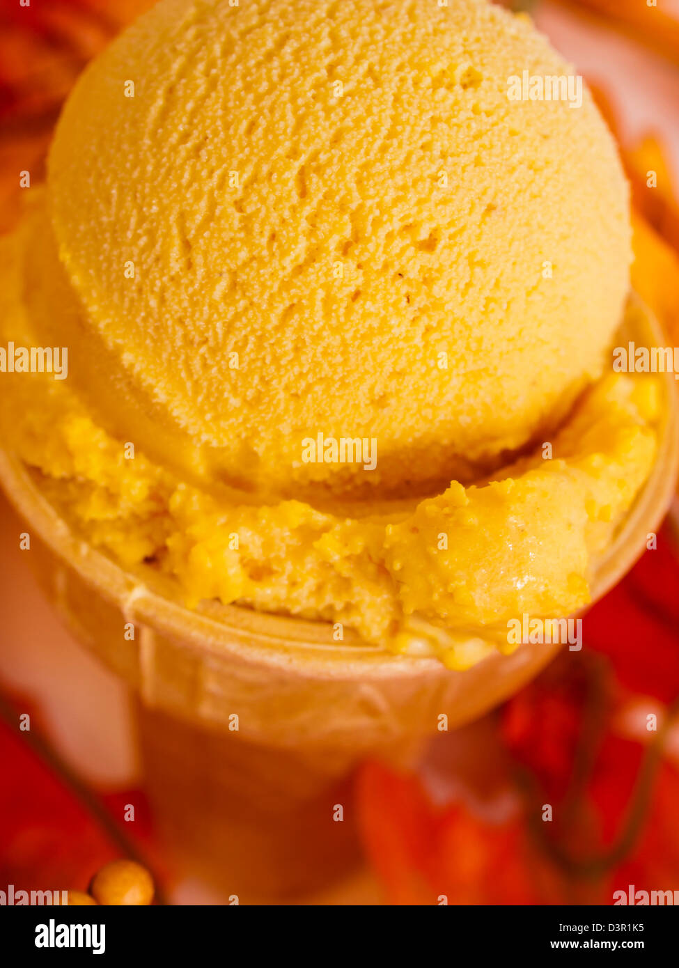 Scoop of gourmet pumpkin gelato in cake cone Stock Photo - Alamy
