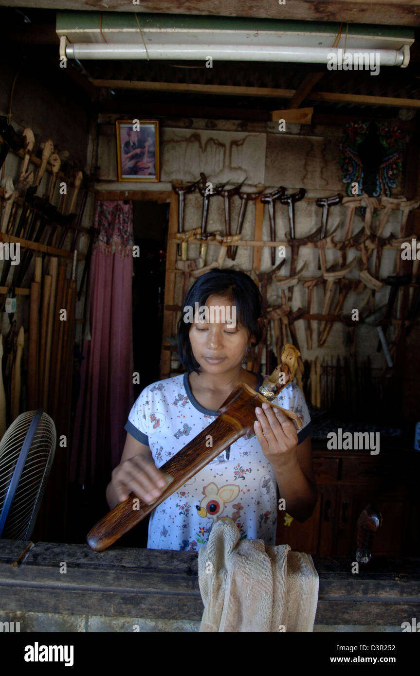 Female kris maker, Nursiyah making kris sheaths in the kris market ...