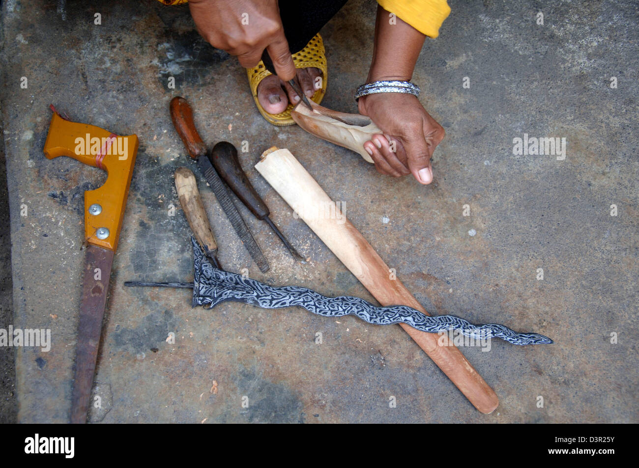 Female kris maker, Hj Mariana making kris sheaths in the kris market ...