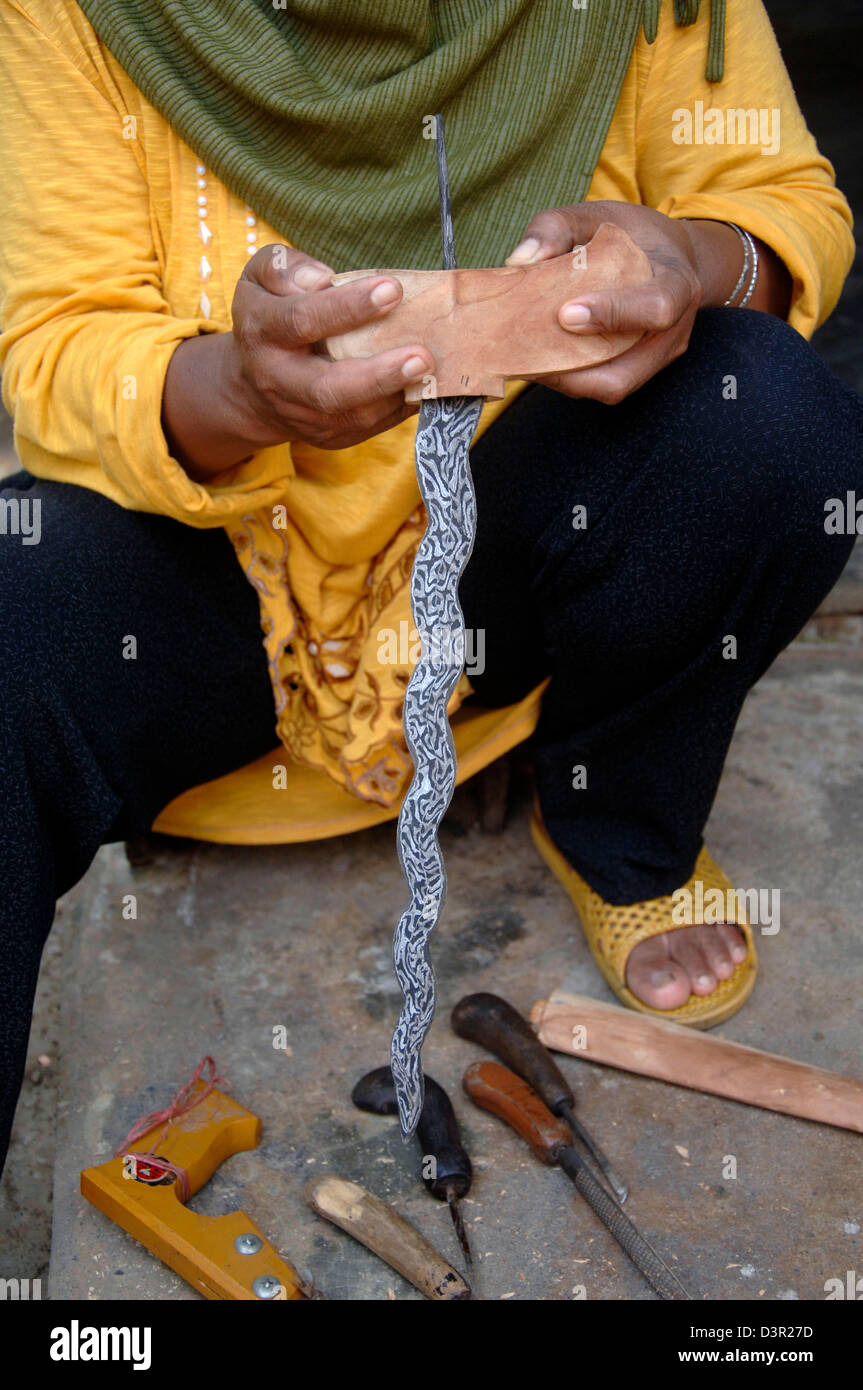 Female kris maker, Hj Mariana making kris sheaths in the kris market ...