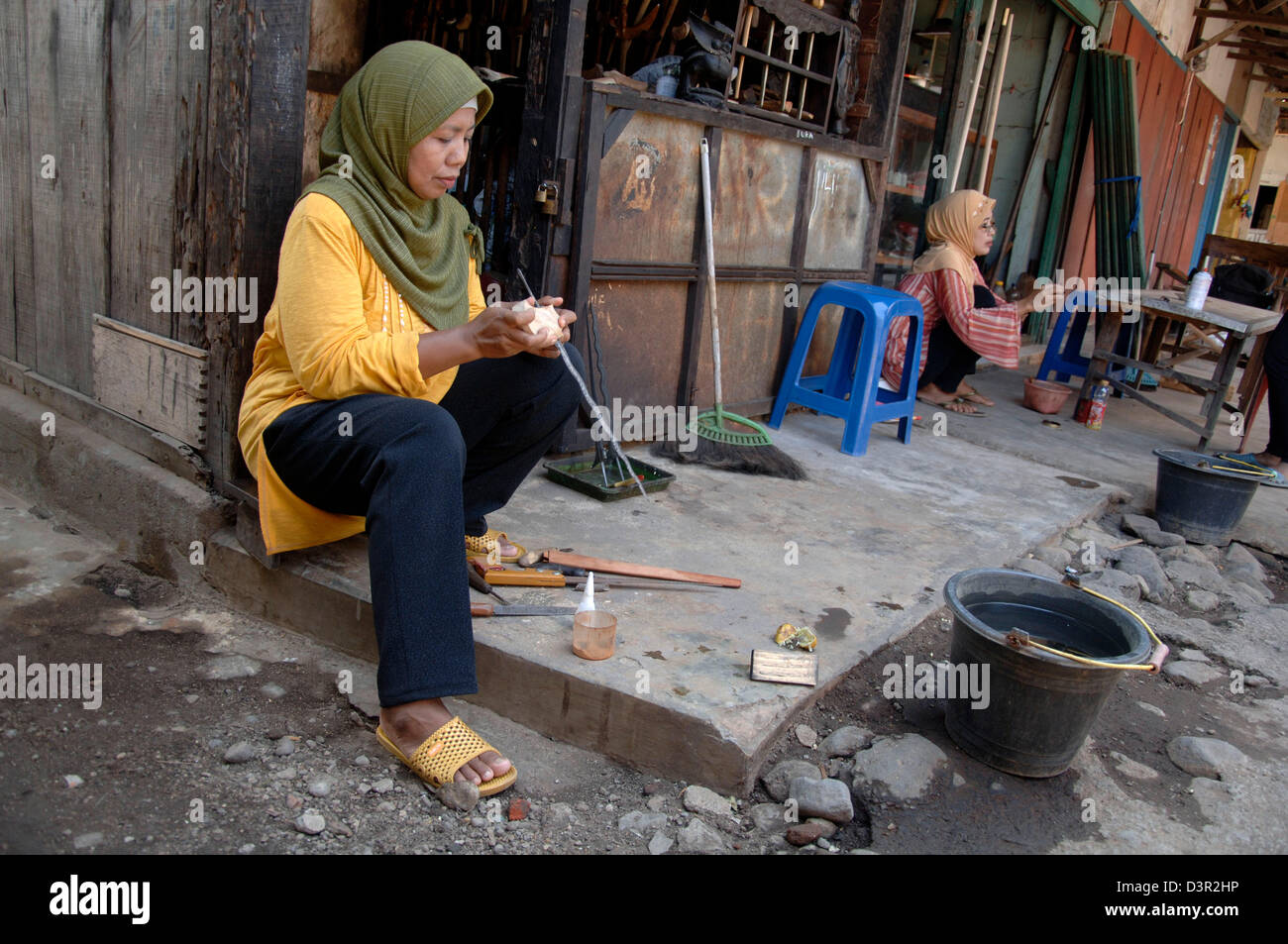Female kris maker, Hj Mariana (left) and Amah (right) making kris ...