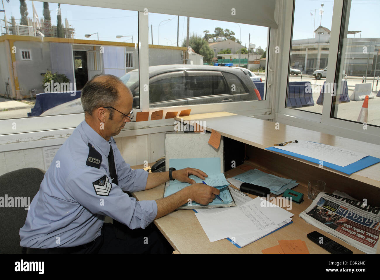 A customs officer at the border crossing Ayios Dhometios, Nicosia ...