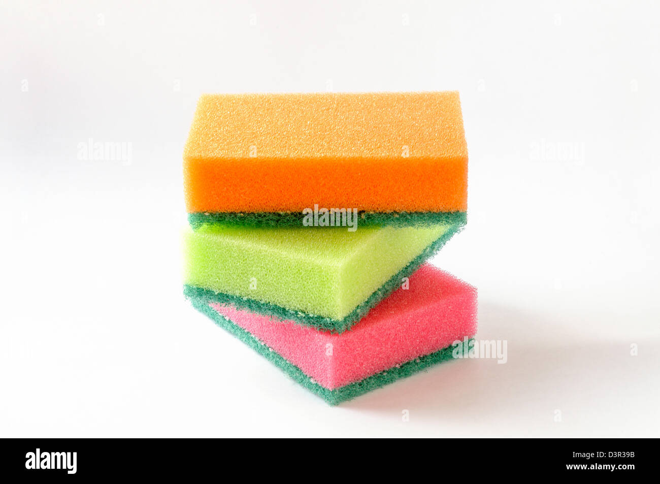 Three colored sponges on a white background Stock Photo - Alamy