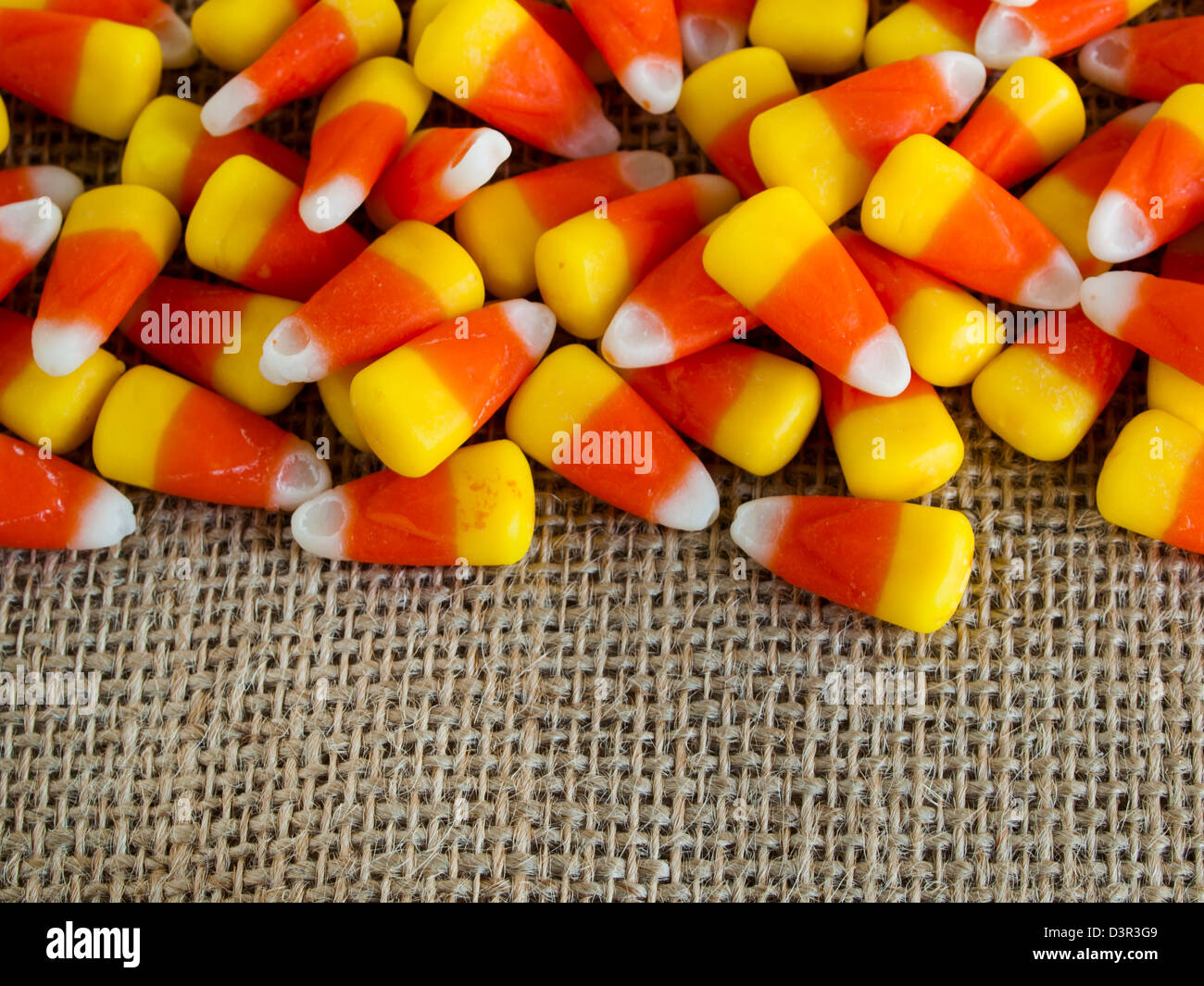Traditional Halloween candies candy corn on burlap fabric Stock Photo ...