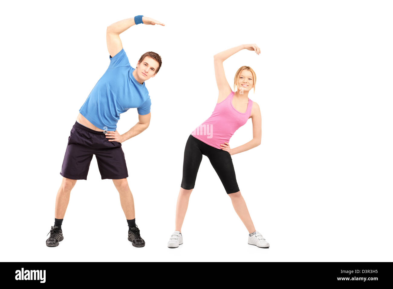 Full length portrait of a young male and female exercising, isolated on ...