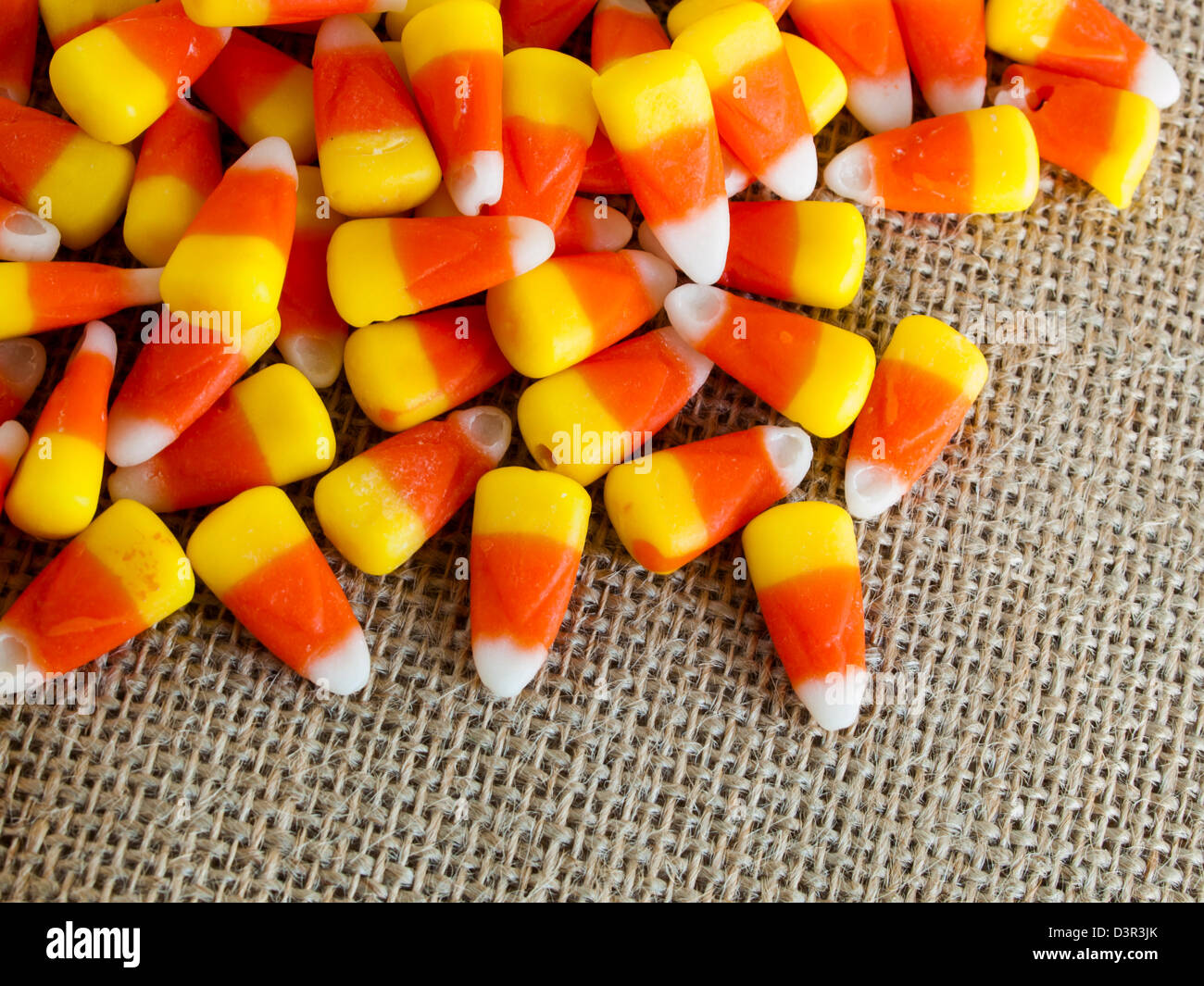 Traditional Halloween candies candy corn on burlap fabric Stock Photo ...