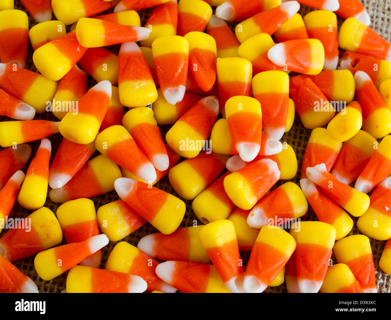 Traditional Halloween candies candy corn on burlap fabric Stock Photo ...