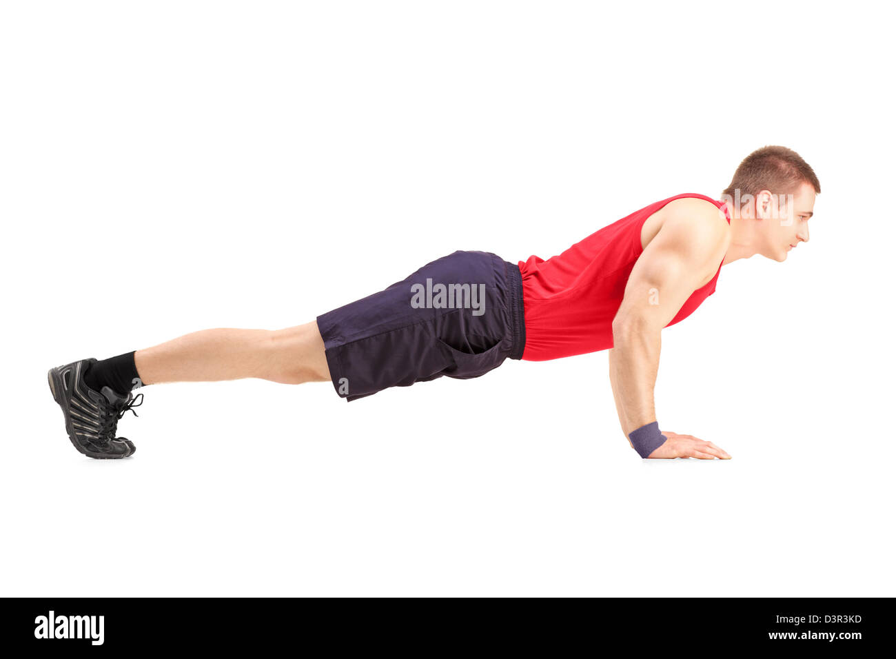 Male athlete in a sportswear doing push ups isolated on white ...