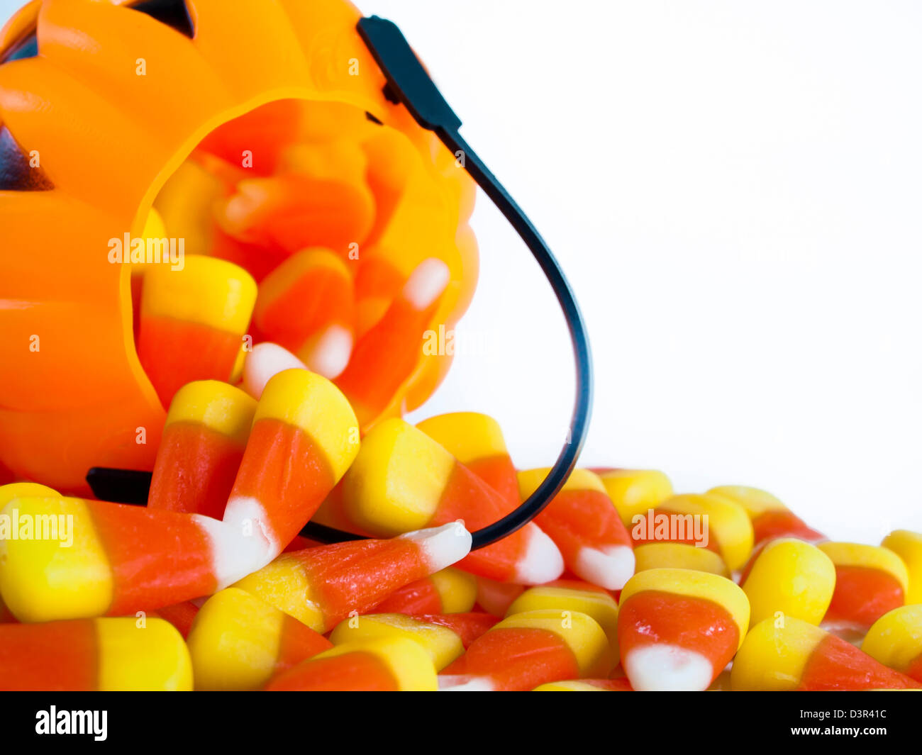 Candy corn candies falling out of Halloween treat bag Stock Photo - Alamy