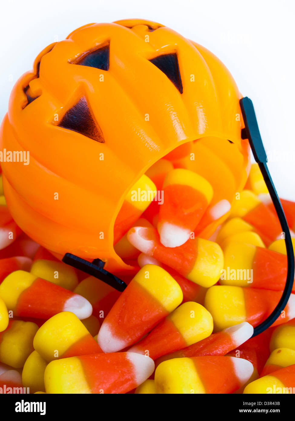 Candy corn candies falling out of Halloween treat bag Stock Photo - Alamy