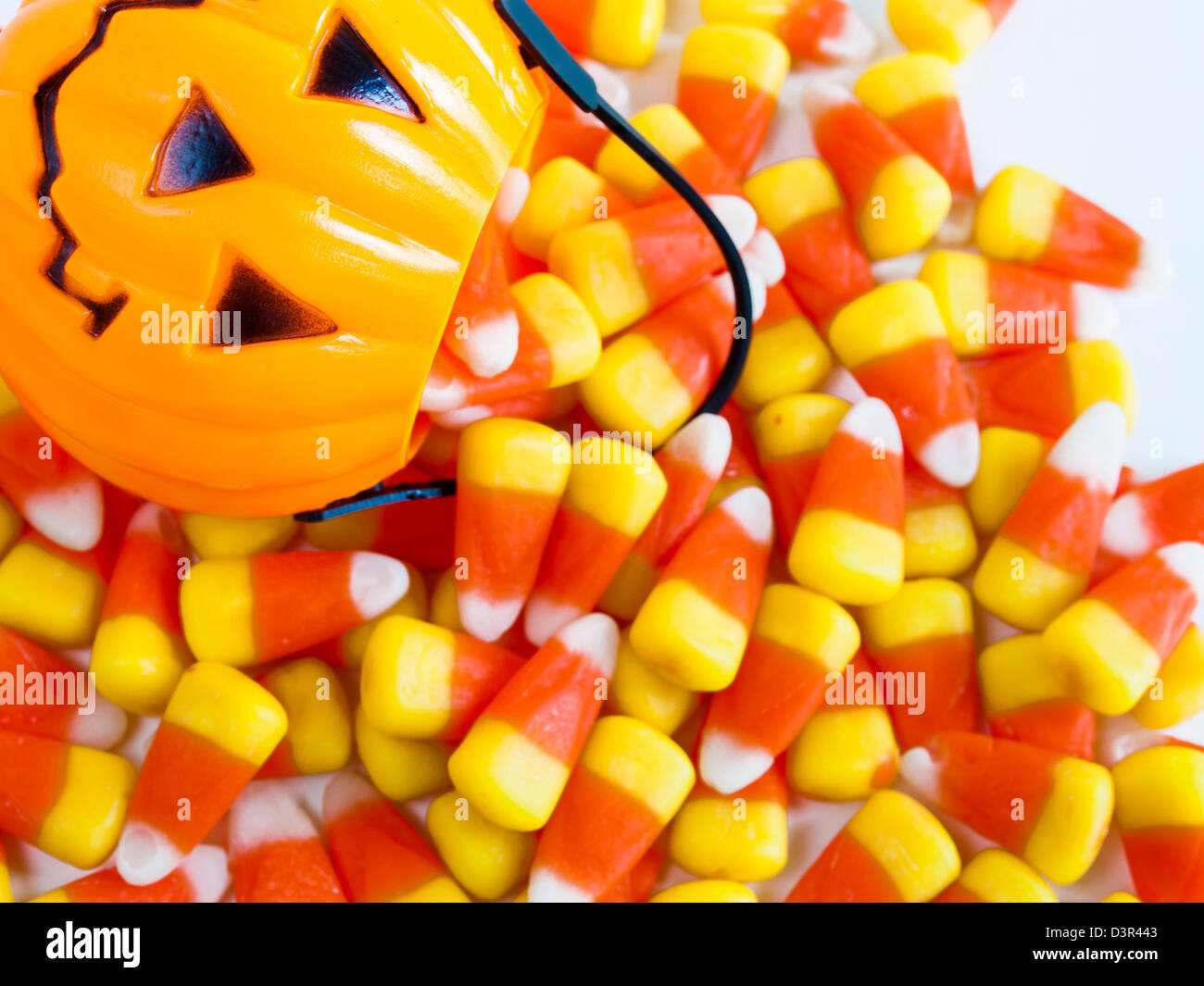 Candy corn candies falling out of Halloween treat bag Stock Photo - Alamy