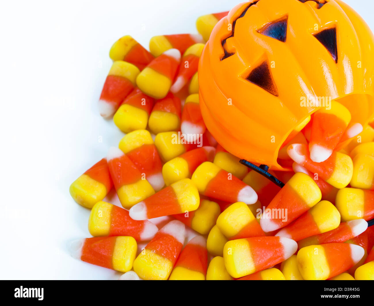 Candy corn candies falling out of Halloween treat bag Stock Photo - Alamy