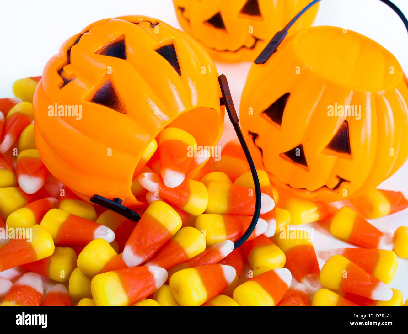 Candy corn candies falling out of Halloween treat bag Stock Photo - Alamy