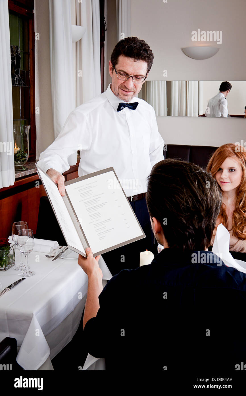man and woman in restaurant waiter bring card and order food Stock ...