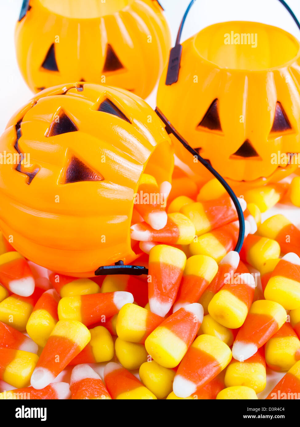 Candy corn candies falling out of Halloween treat bag Stock Photo - Alamy