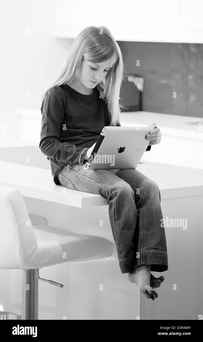 Young girl playing on an apple iPad tablet computer Stock Photo - Alamy