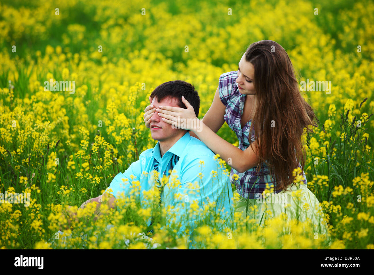 lovers hug on yellow flower field Stock Photo - Alamy