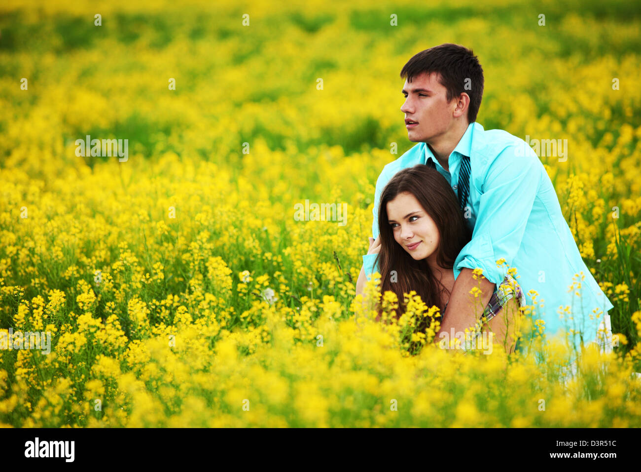 lovers hug on yellow flower field Stock Photo - Alamy