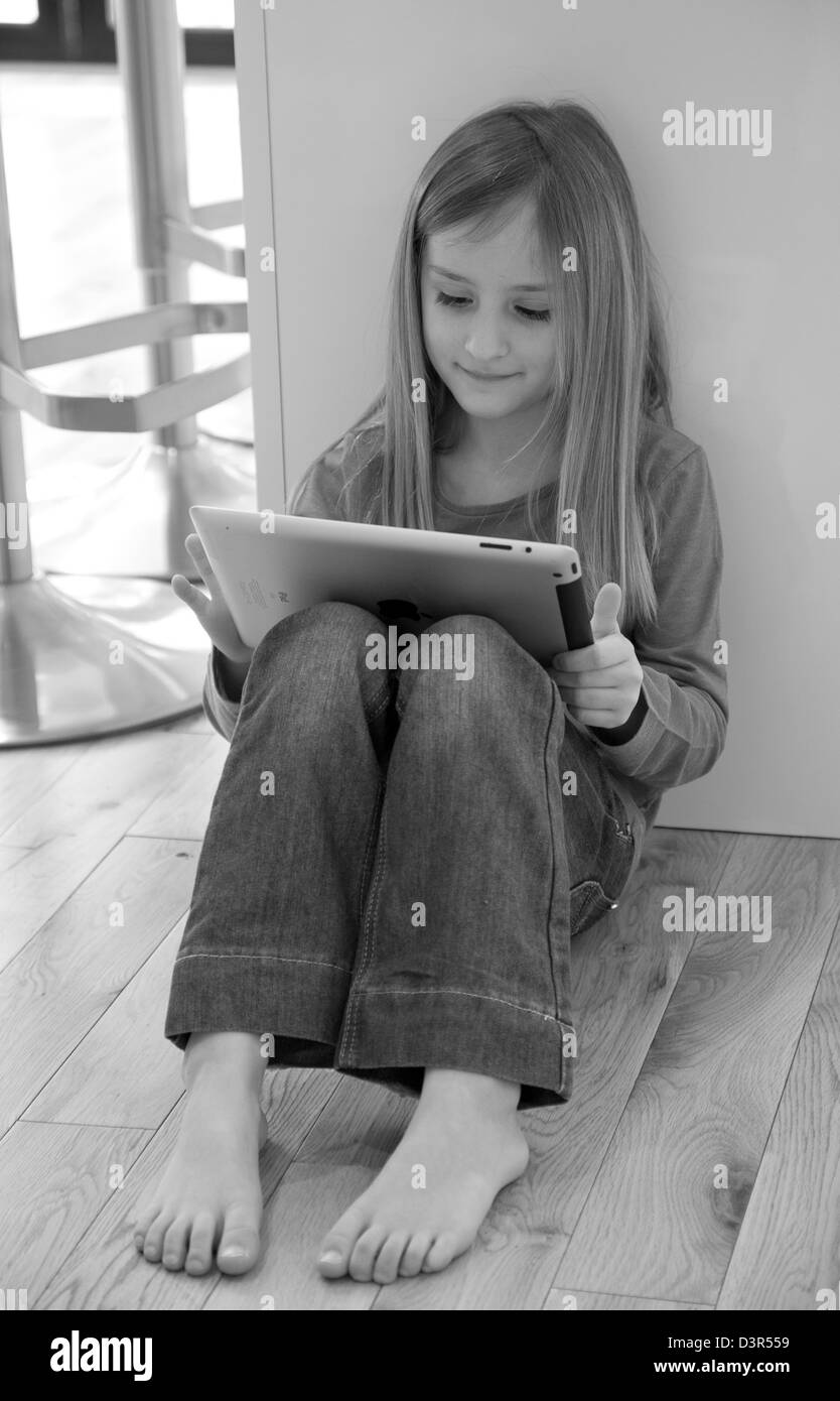 Young girl playing on an apple iPad tablet computer Stock Photo - Alamy