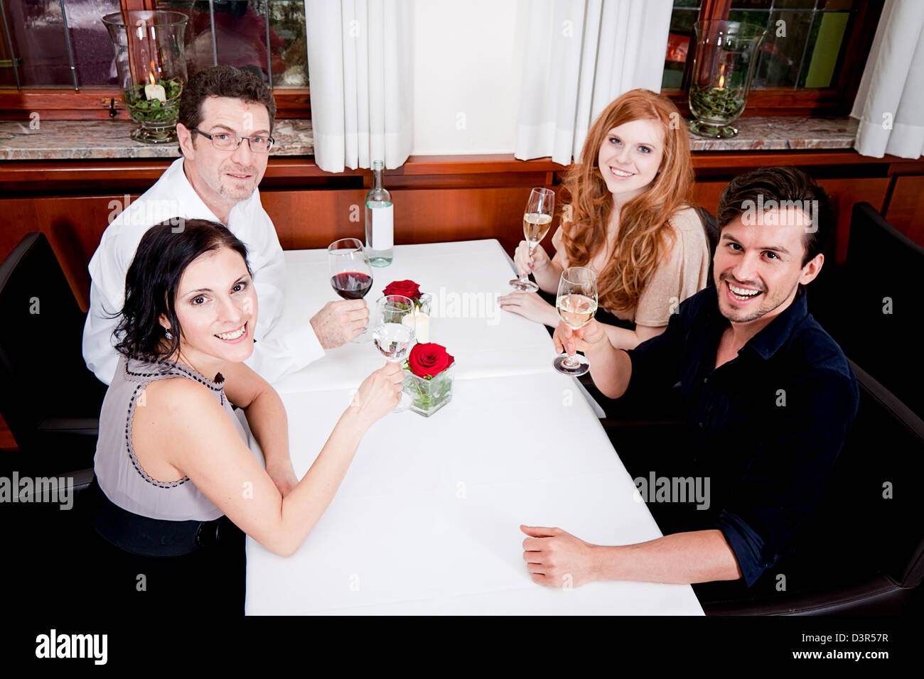 smiling happy people in restaurant drinking talking having fun Stock ...