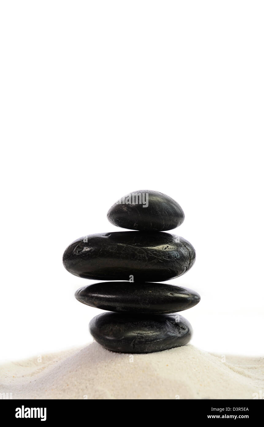 Hot Stones stacked on white sand Stock Photo - Alamy