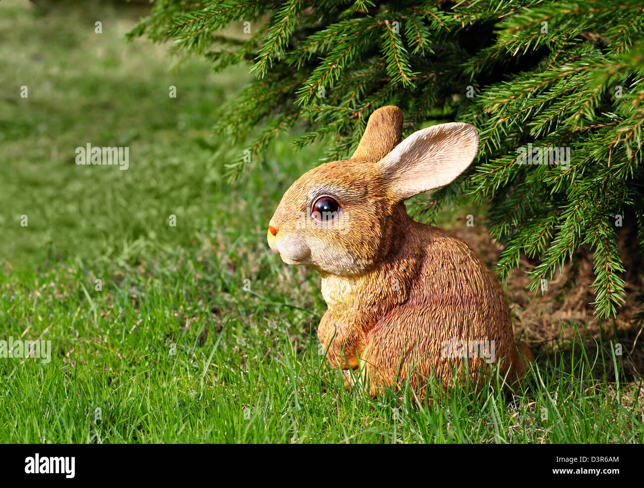 Brown rabbit toy in the green garden Stock Photo - Alamy