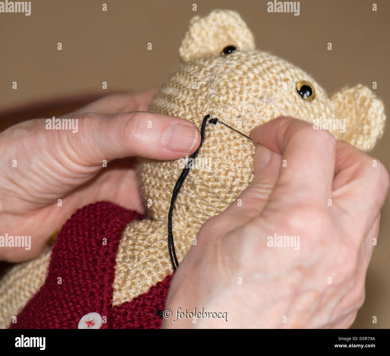 Close up of lady stitching a teddy bear doll Stock Photo - Alamy