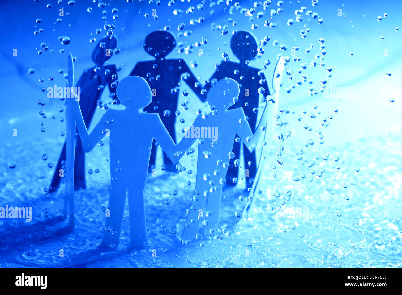 paper team linked together under rain weather concept Stock Photo - Alamy
