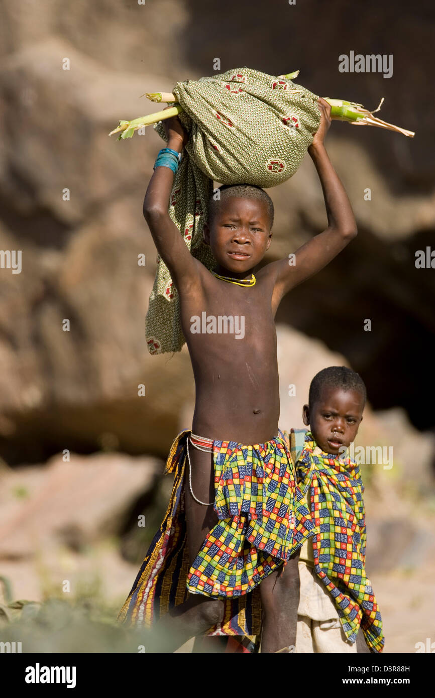 Local Himba boys travelling beside the Kunene river, Namibia Stock ...