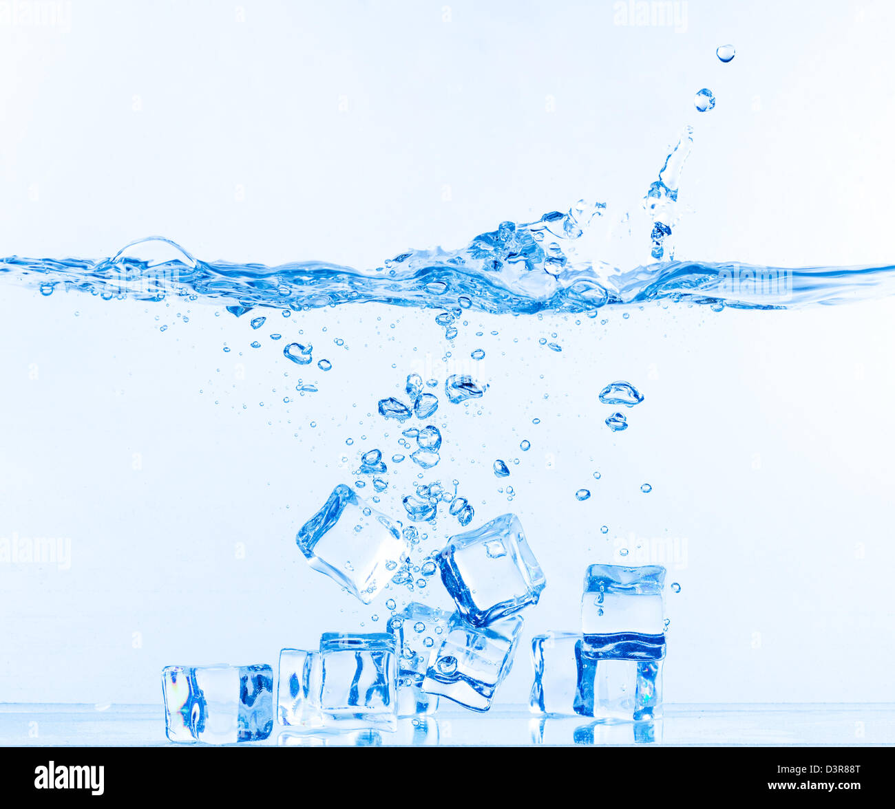 Ice Cubes Dropped into Water with Splash on white Stock Photo - Alamy