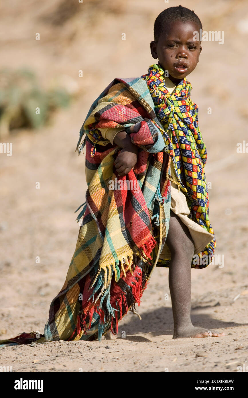 Young Himba boy walking with blankets, Kunene river, Namibia Stock ...