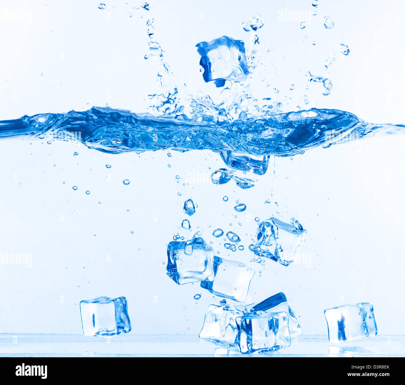Ice Cubes Dropped into Water with Splash on white Stock Photo - Alamy
