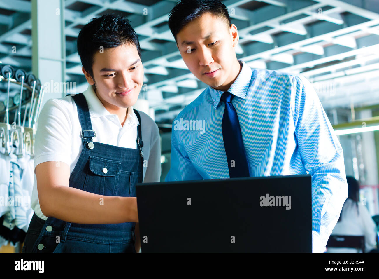 Chinese Worker or production manager and owner, ceo or controller, look ...