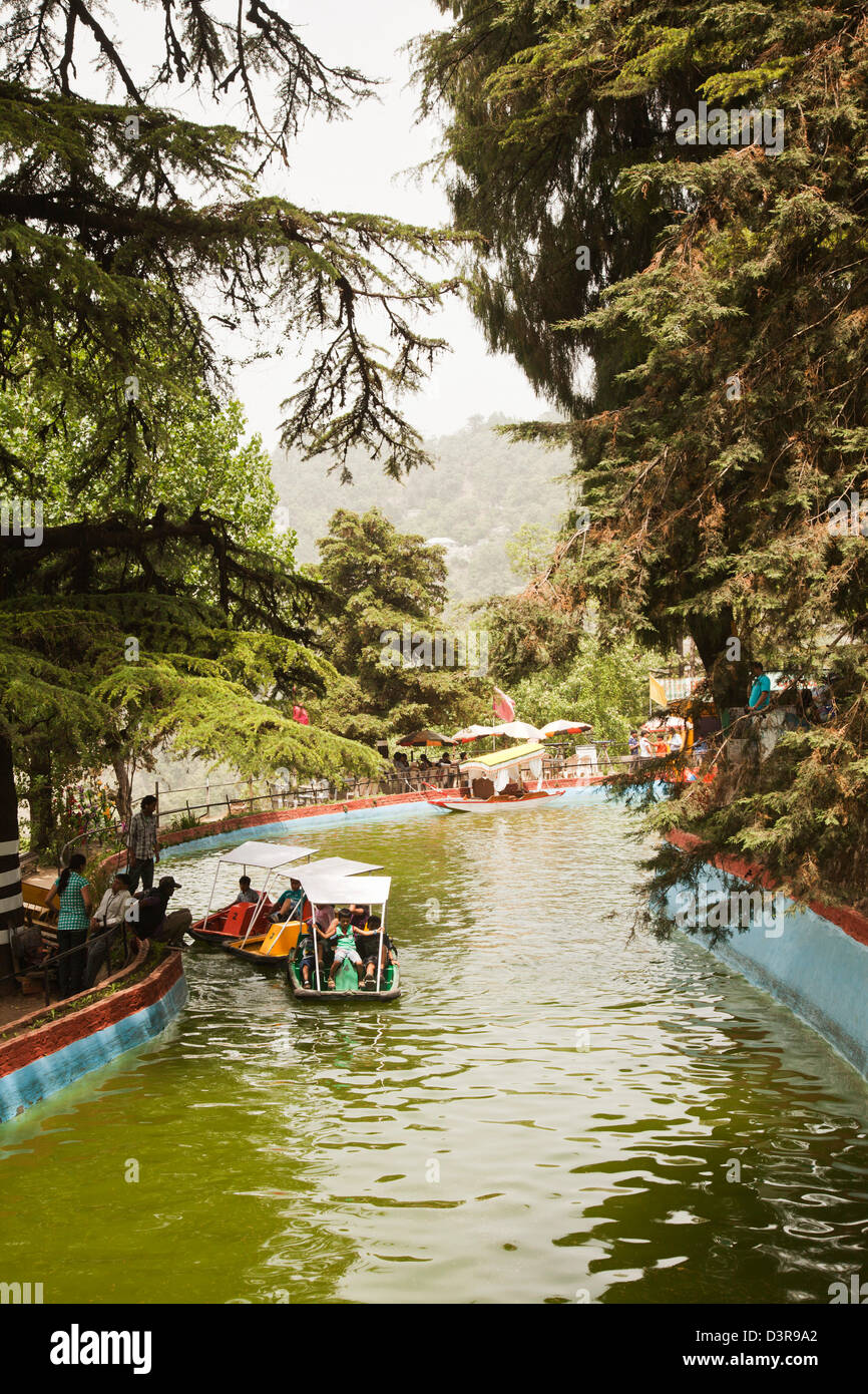Tourists boating in an artificial canal at Company Bagh, Mussoorie ...