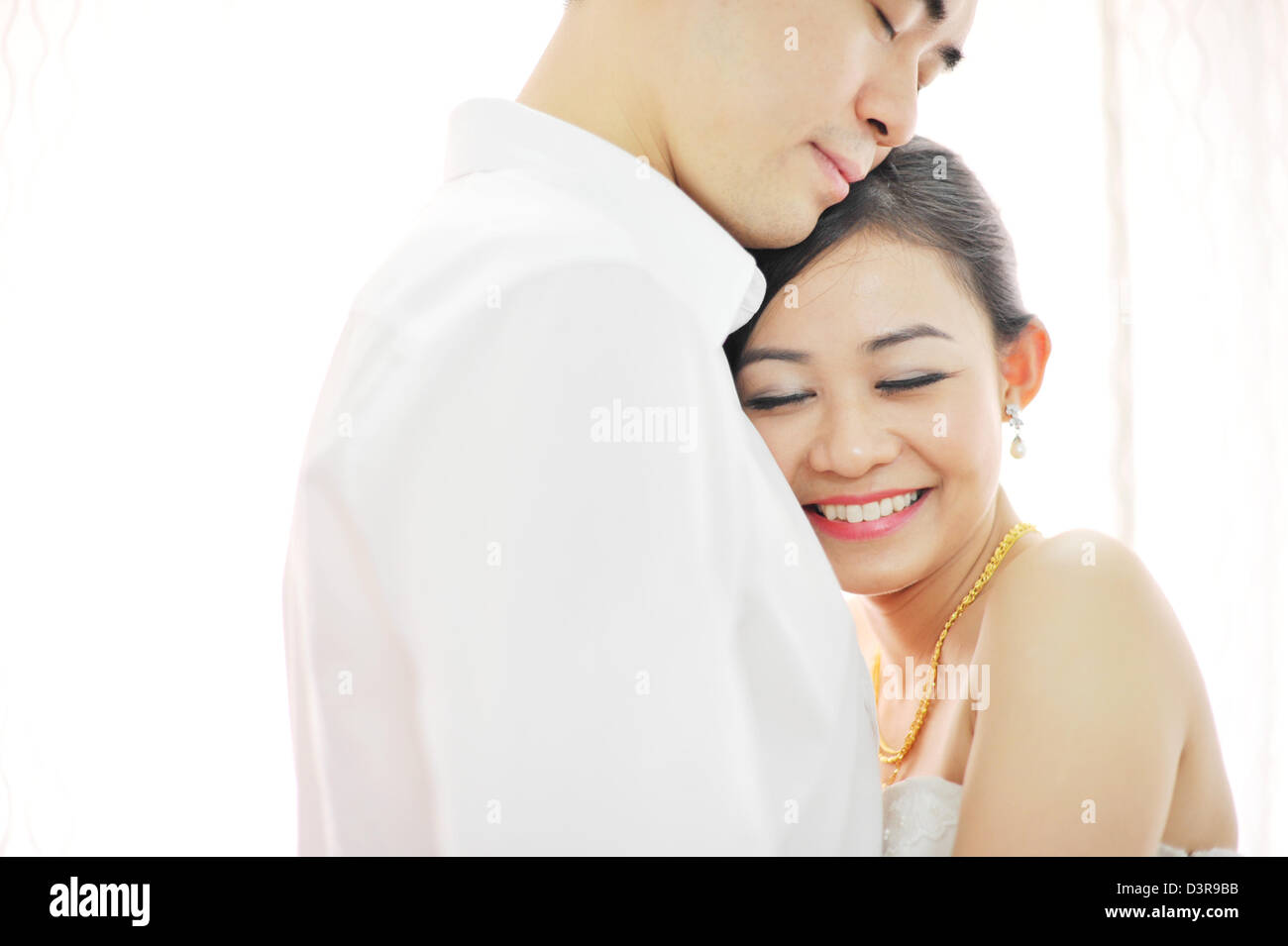 Asian Chinese wedding couple in love. Romantic groom and bride dancing ...