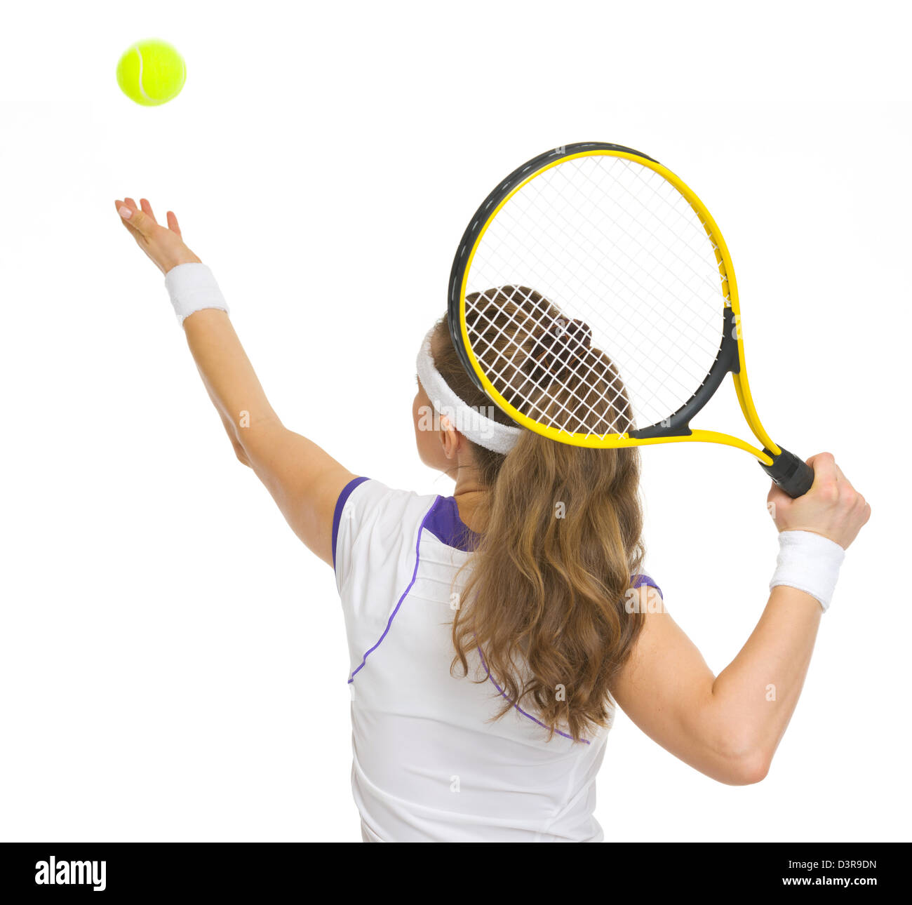 Tennis player serving ball. rear view Stock Photo - Alamy