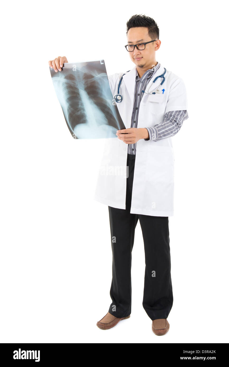Full body Asian medical doctor checking on x-ray image standing ...