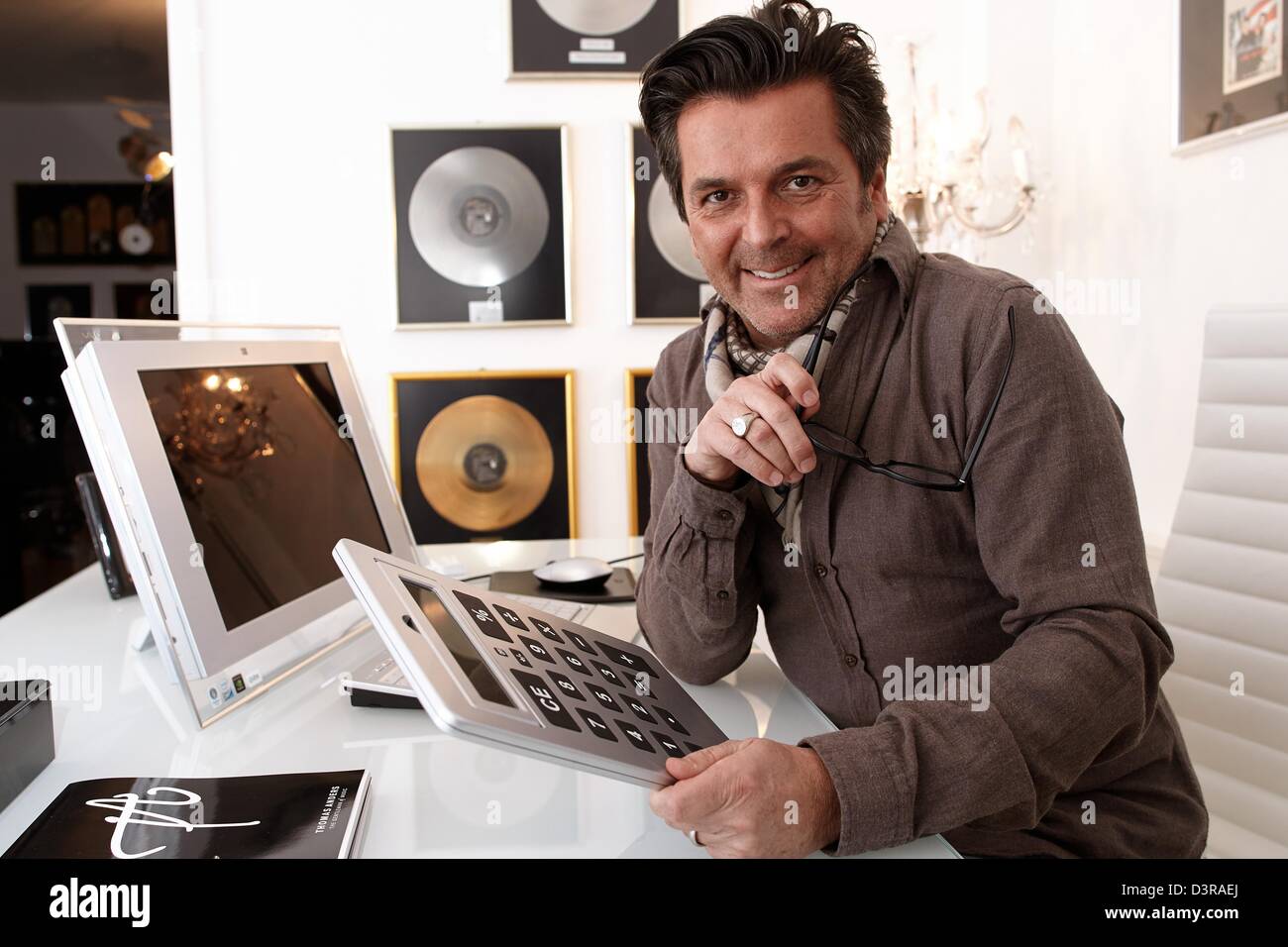 German pop singer and producer Thomas Anders sits at his desk in his ...