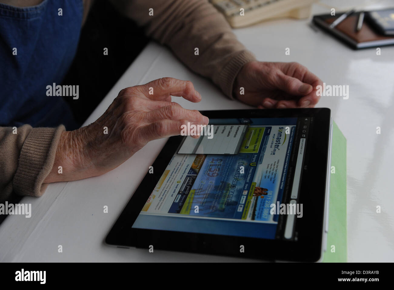 Elderly lady playing a game on an Apple Ipad at home Stock Photo - Alamy