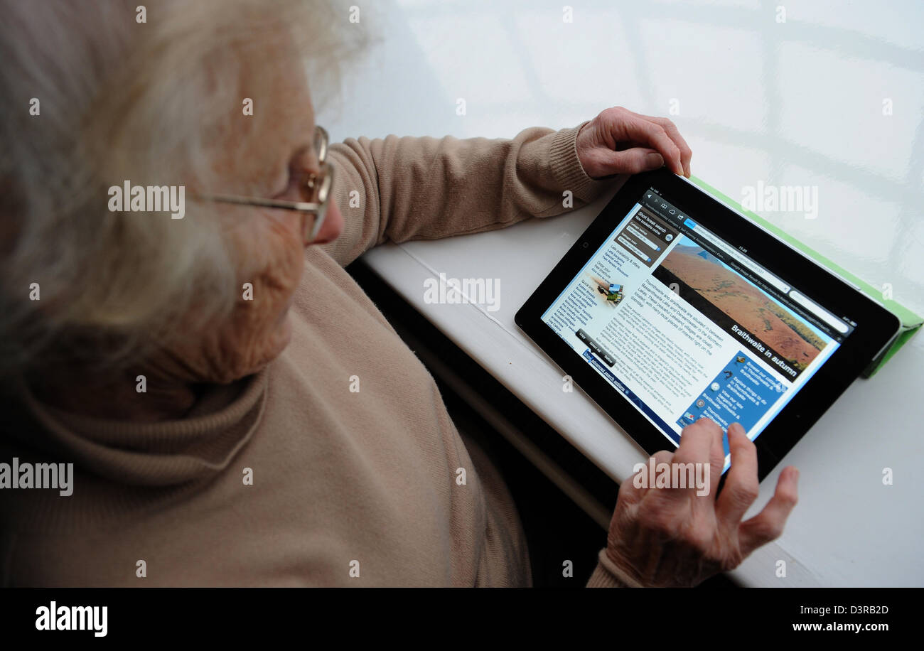 Elderly lady playing a game on an Apple Ipad at home Stock Photo - Alamy