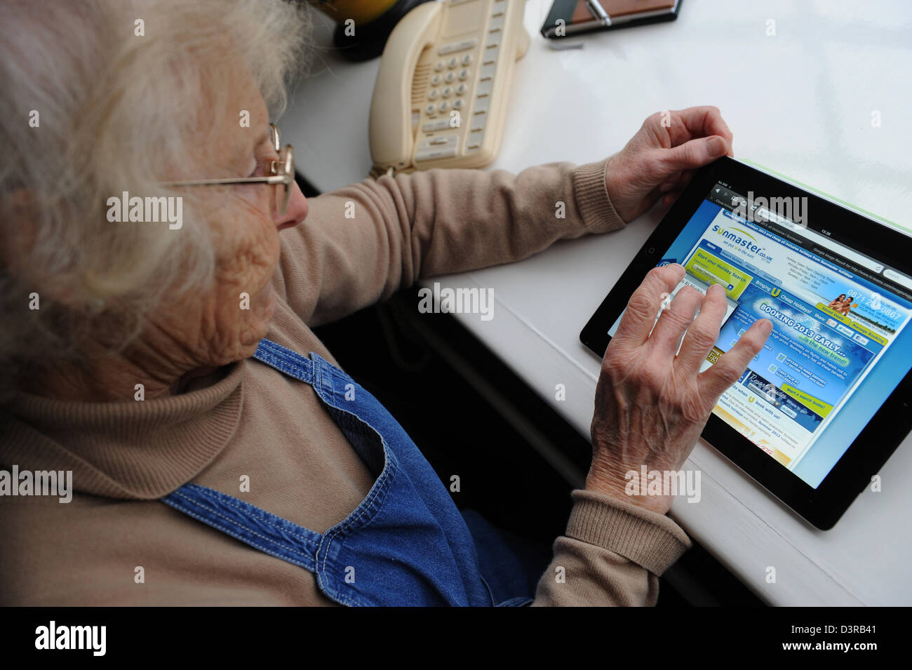 Elderly lady playing a game on an Apple Ipad at home Stock Photo - Alamy