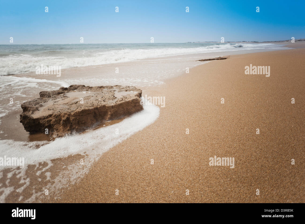 Surf with rock on the beach, Dwarka Beach, Dwarka, Gujarat, India Stock ...