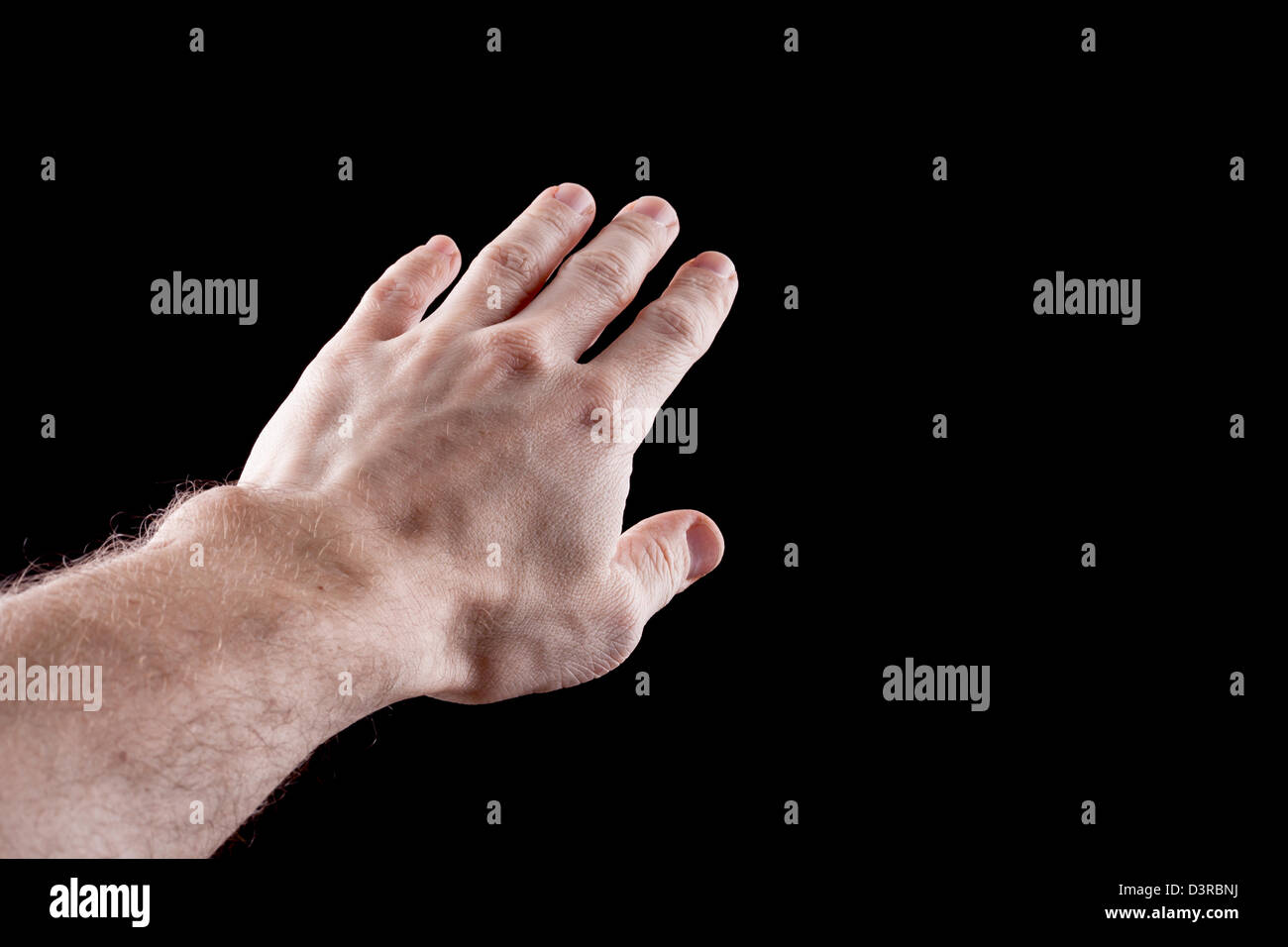 Man's hand isolated on black background Stock Photo - Alamy