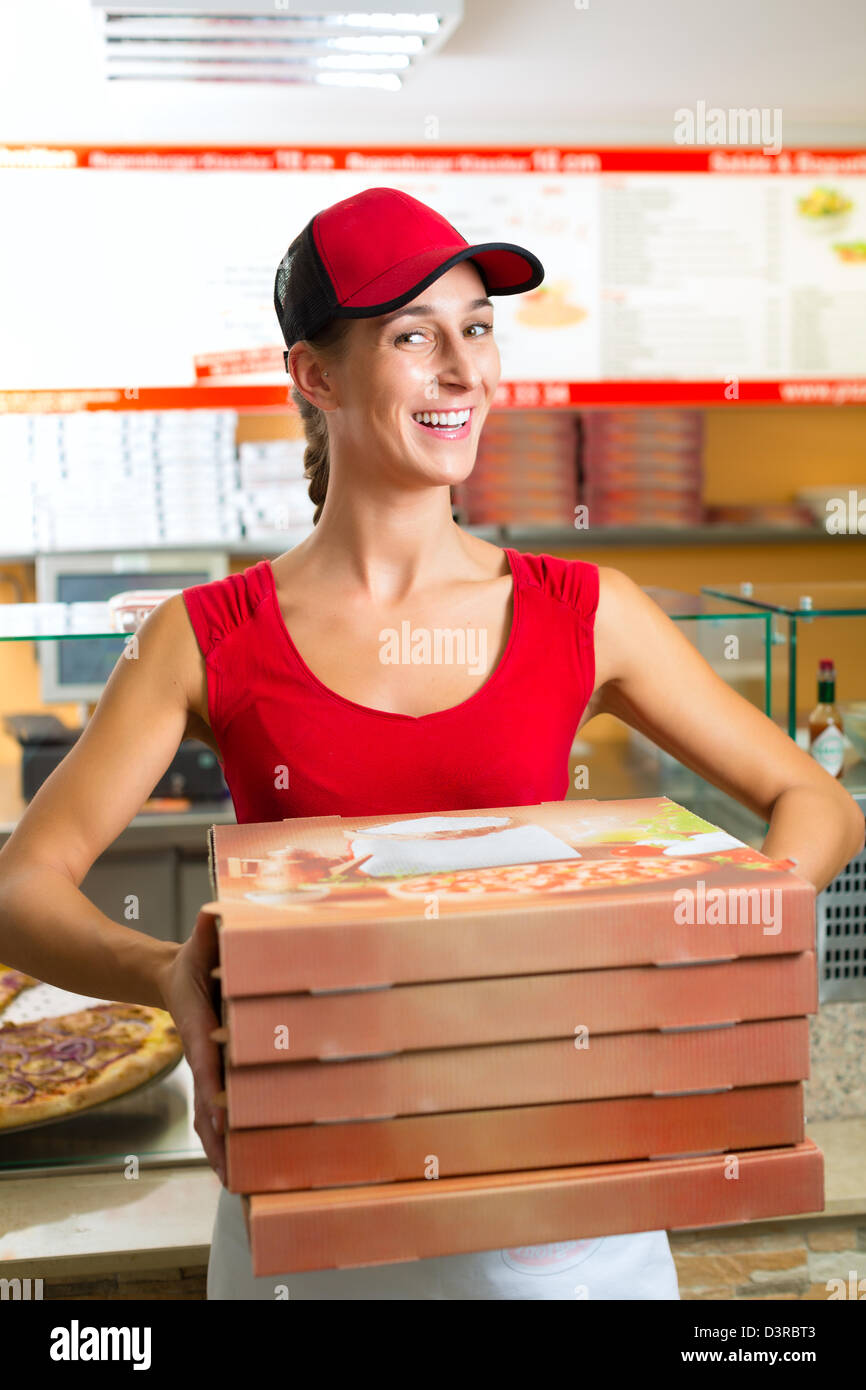 Woman holding several pizza boxes and smiling Stock Photo - Alamy