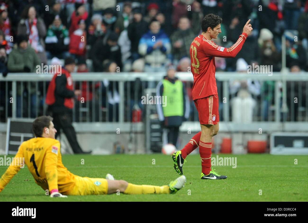 Munich's Mario Gomez celebrates his goal while Bremen's goalkeeper sits ...