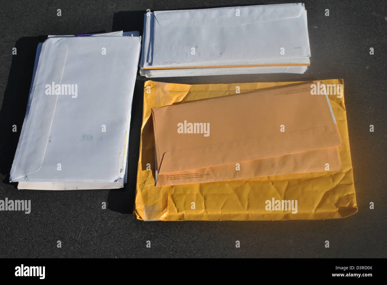 3 seperate stacks of mail on desk Stock Photo - Alamy