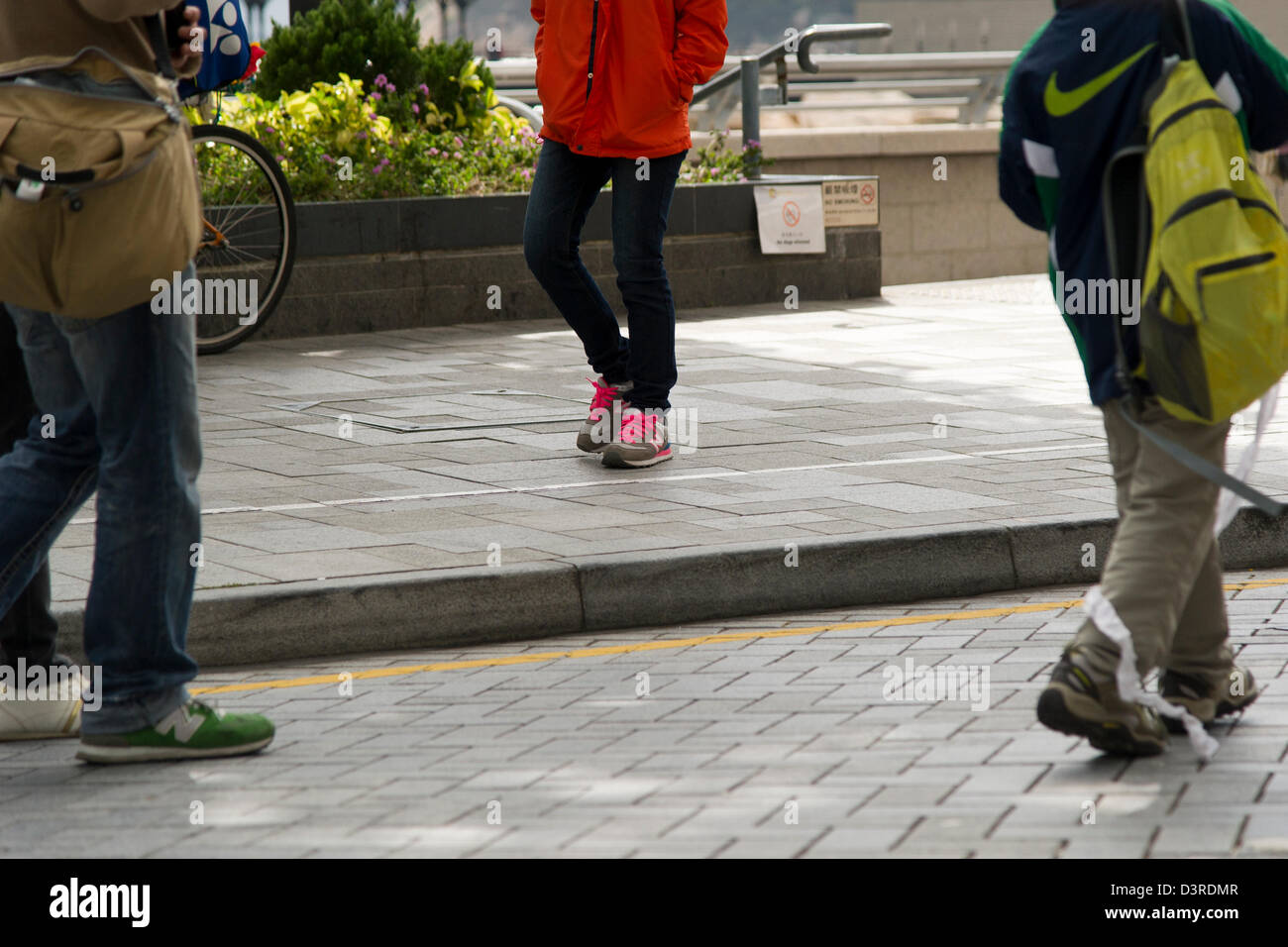The legs and feet of passersby are visible on Stanley promenade in Hong ...