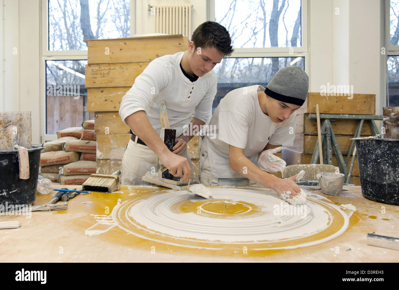 Berlin, Germany, plasterer apprentices in creating plaster rings Stock ...
