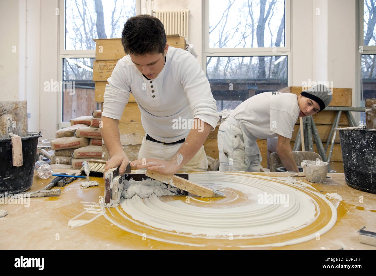 Berlin, Germany, plasterer apprentices in creating plaster rings Stock ...